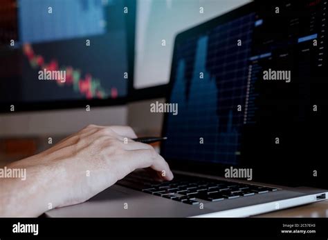 Businessman Typing On Keyboard Laptop And Working Trading Stock Market In Office Room Stock