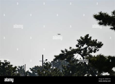 A Small Unmanned Aircraft System Flies Overhead During A Routine