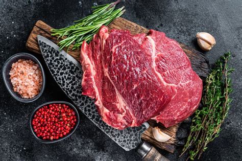 Raw Chuck Eye Roll Black Angus Prime Beef Steak On Butcher Board With