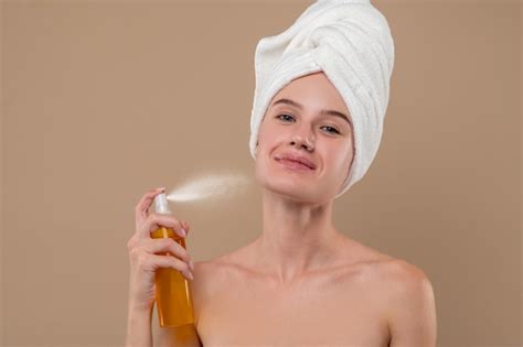 Premium Photo Young Girl Spraying Hydrating Mist On Her Face