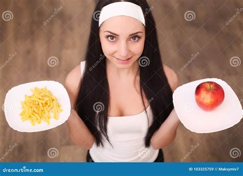 Portrait Of A Gorgeous Young Brunette Woman Showing Diet Food Choices