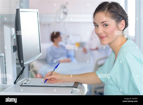 Nurse With Clipboard At Computer Stock Photo Alamy