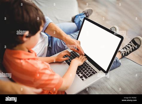 Father And Son Working On Laptop Stock Photo Alamy