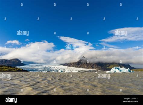 Fjallsarlon Lagoon With Glacier And Mountains Covered With Clouds On A
