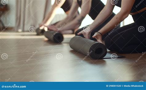 Three Beautiful Slim Women Spreading Out Yoga Mats Before Training In