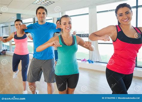 Portrait Of Fitness Class And Instructor Doing Pilates Exercise Stock