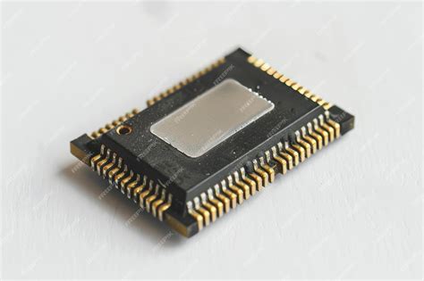 A Closeup View Of A Tiny Black Circuit Board With Gold Connectors
