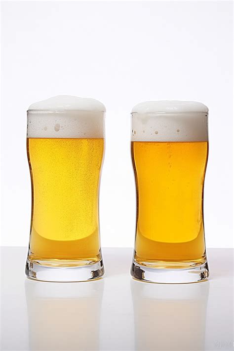 Two Glasses Of Beer Over A Bright Yellow Background Photo And Picture