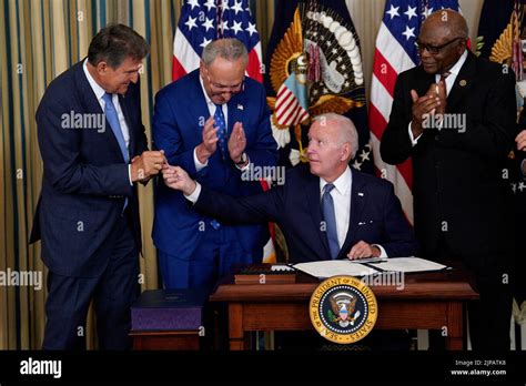 Us President Joe Biden Holds Out His Pen To Senator Joe Manchin D Wv