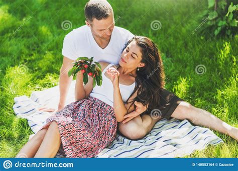 Couple In Love Sitting On A Picnic Blanket Outdoor Eating Healthy