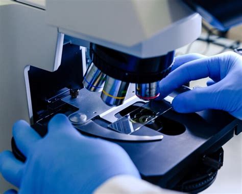 Premium Photo Cropped Hands Of Scientist Using Microscope In Laboratory