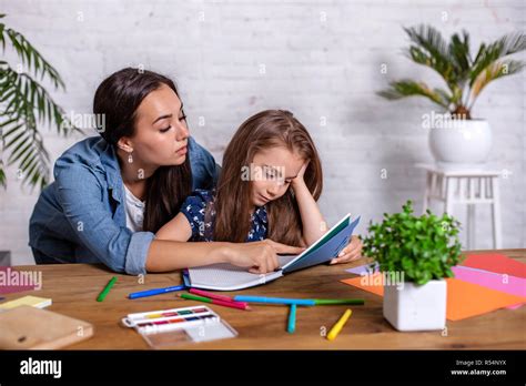 Mother Becoming Frustrated With Daughter Whilst Doing Homework Sitting