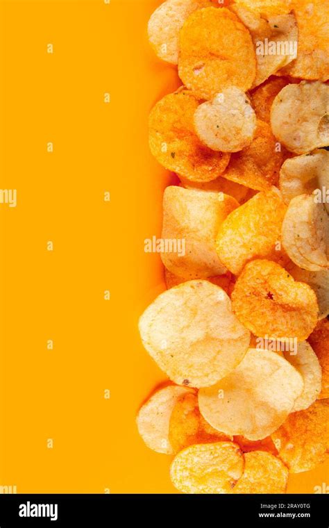 Border Of Potato Chips Isolated On Orange Colored Background Mouthwatering Chip That Is Coated