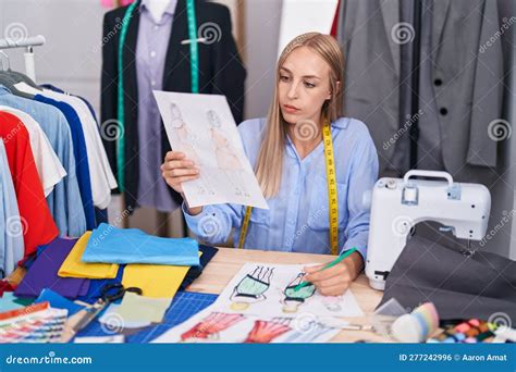 Young Blonde Woman Tailor Drawing Clothing Design At Tailor Shop Stock