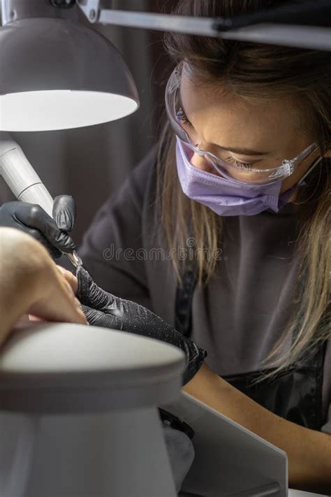 Manicurist At Work Professional Manicurist Removes Worn Nail Design