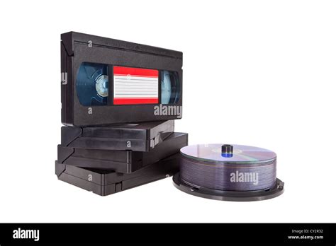 Old Video Cassette Tapes With A Dvd Disc Isolated On White Background