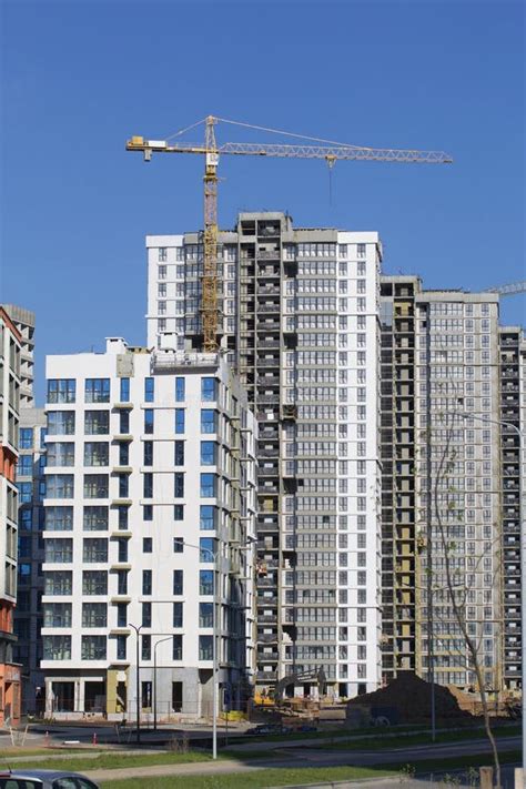 Construction Site Reinforced Concrete Frames Of Multi Storey Buildings And Construction Cranes