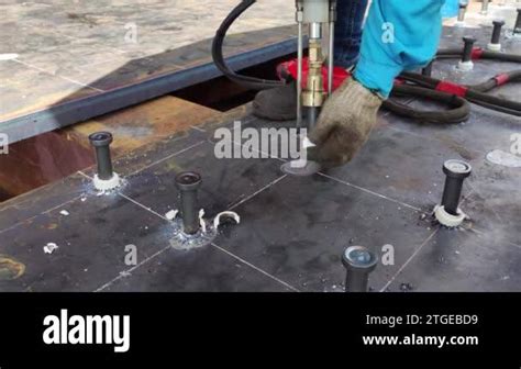 Welder Is Using A Stud Welding Machine To Weld Stud Bolt On Steel