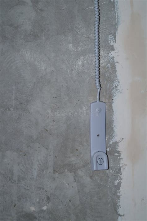 Intercom Phone Receiver On Gray Concrete Background Handset Hanging On