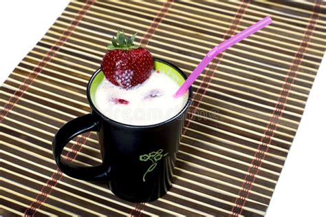 Milk Cocktail In A Black Mug Is Decorated With Strawberry Stock Image