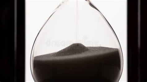 Macro Of Sand Grains Particles Running Inside Hourglass Measuring