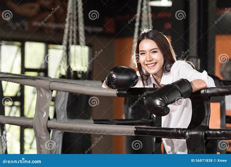 Businesswoman Boxer In Suit And Boxing Gloves On Boxing Ring Smiling
