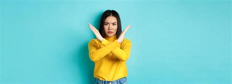 Free Photo Serious And Assertive Korean Woman Showing Cross Stop