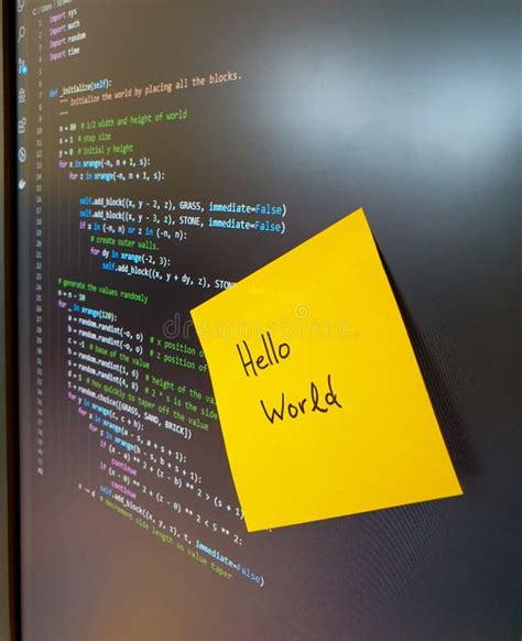 Computer Screen Showing Python Code With Yellow Sticker Saying Hello