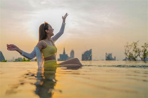 Black Silhouette Of Asian Woman Splash Water On Summer Vacation Holiday