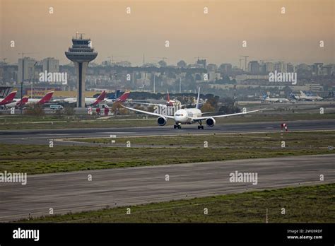 An airplane racing down the runway just before takeoff near the control ...