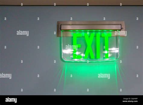 Lit Exit Sign On A Wall Stock Photo Alamy