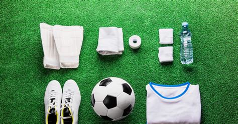 인조 잔디에 대한 축구 공 클리트 및 다양한 축구 재료 스튜디오는 녹색 배경에 촬영했습니다 플랫 레이 널링 사진