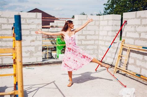 Happy Young Woman Dancing In Her House Under Construction Future Owner