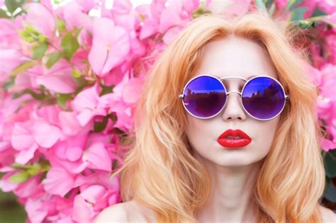 Premium Ai Image A Woman Wearing Sunglasses And A Pink Flower Background