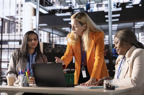 Diverse Team Of Women Collaborate In A Problem Solving Meeting Stock