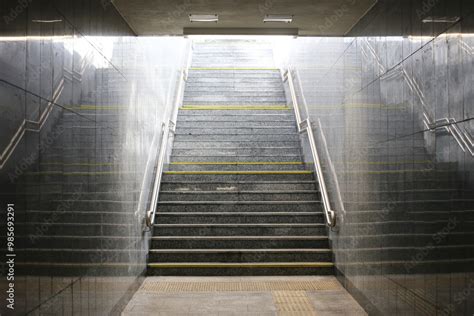 Underground Tunnel Stairs Under Train Tracks With A Bright End Illuminated Passageway Leading