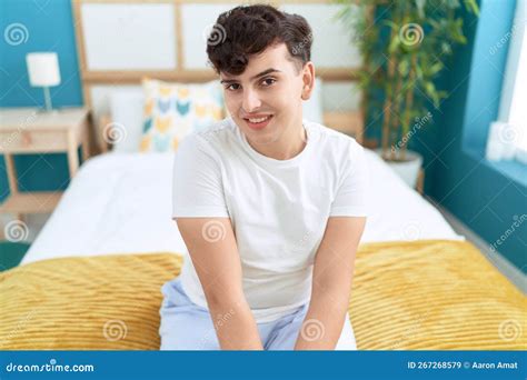 Non Binary Man Smiling Confident Sitting On Bed At Bedroom Stock Image