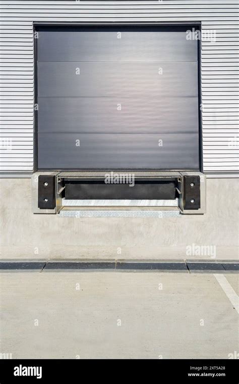 Industrial Loading Dock With Closed Roller Shutter Door Stock Photo Alamy