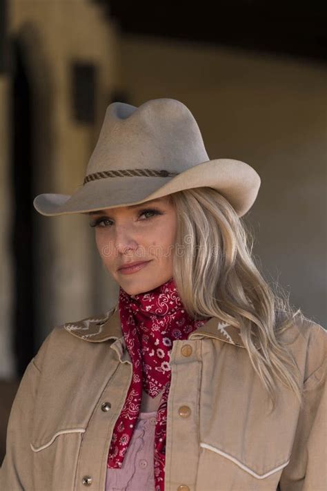 A Lovely Blonde Model Dressed As A Cowgirl Enjoys The American West