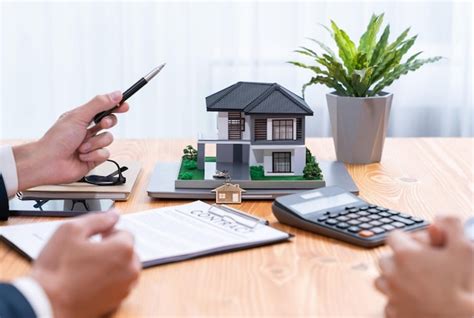 Premium Photo House Model Is Displayed On Wooden Meeting Table With