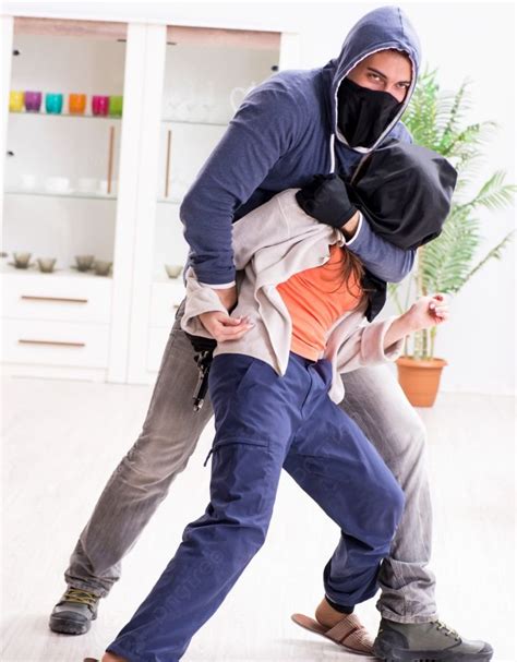 The Armed Man Assaulting Young Woman At Home Armed Man Assaulting Young