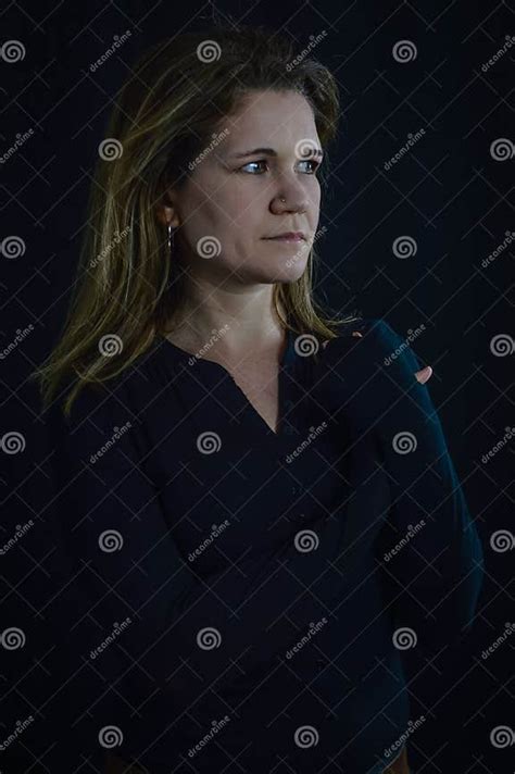 Portrait Of A Beautiful Elegant Blonde Woman With Her Hands Together