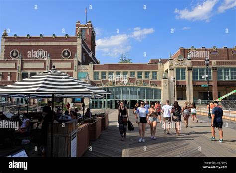 Visitors On Asbury Park Beach Boardwalk With Convention Hall In The Background Asbury Park New