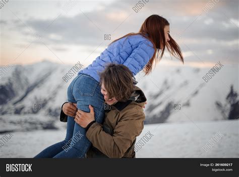 Guy Carrying Girlfriend Over Shoulder