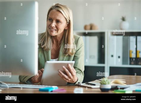 Thats It A Mature Businesswoman Working On A Tablet In Her Corporate