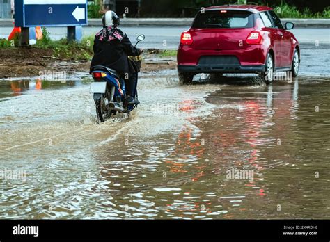 Woman Ride Motorcycle Passing Through Flooded Road Riding Motorbike On