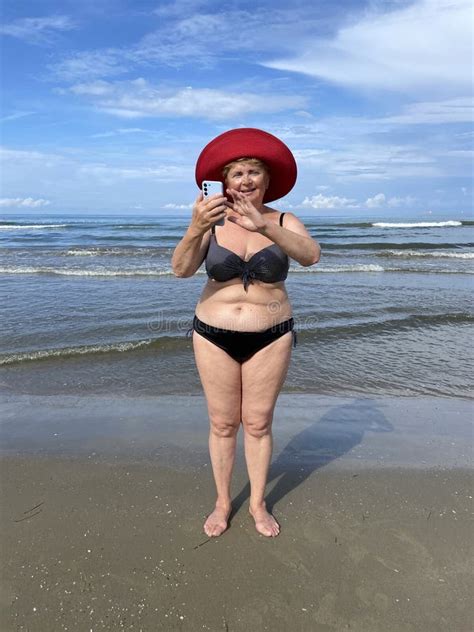 Senior Adventure Is Ageless Woman Wearing In Swimsuit Speak By Mobile
