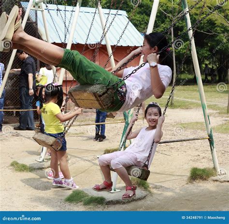 Happy Girls On Swings In City Park Editorial Photo Image Of Girl