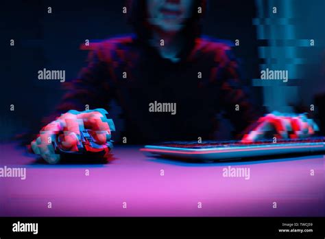 Hacker In The Hood Working With Computer Typing Text In Dark Room