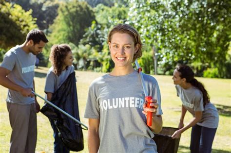 Premium Photo Team Of Volunteers Picking Up Trash